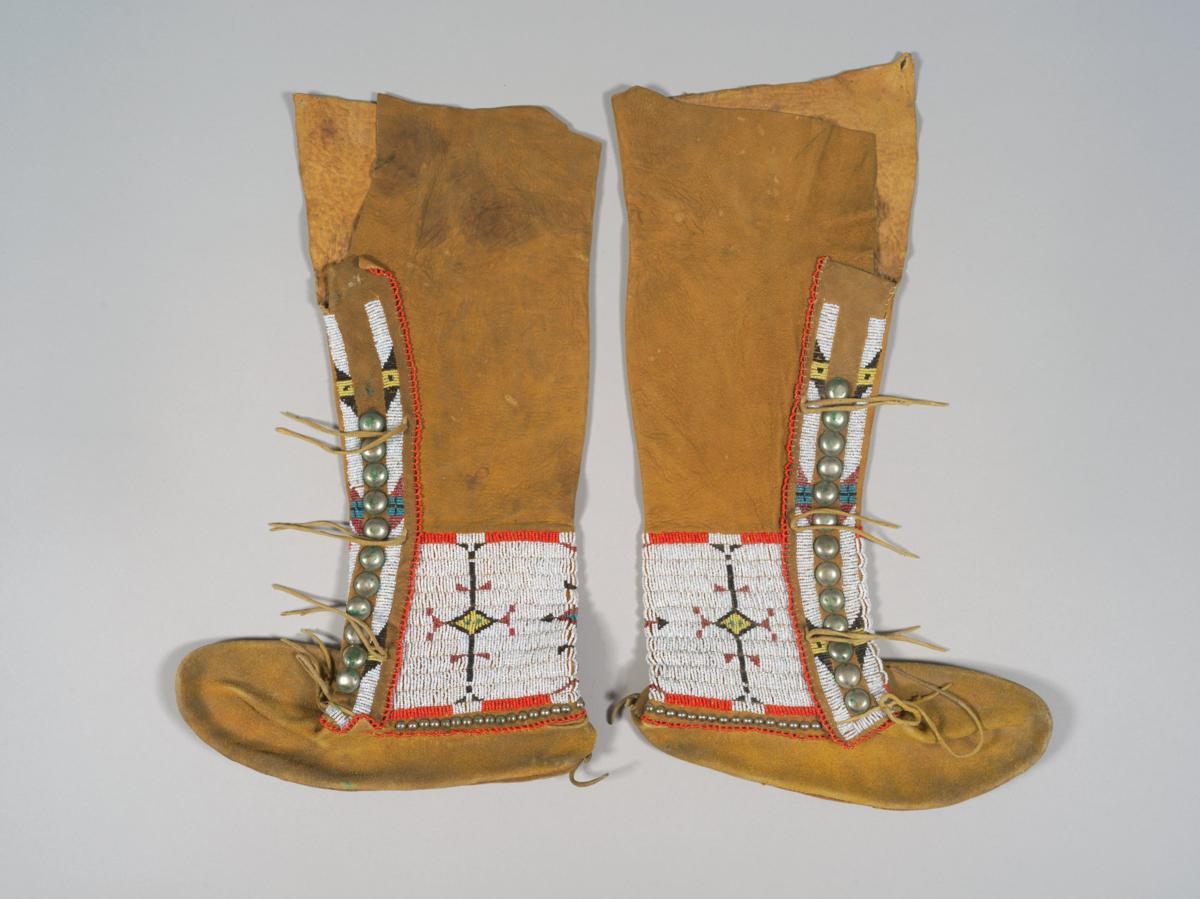 Beaded and painted leather moccasin with geometric designs and fringe